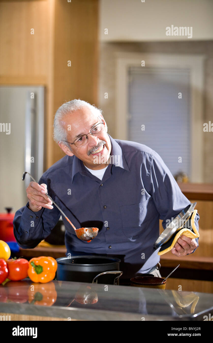 Elderly man cooking alone hi-res stock photography and images - Alamy