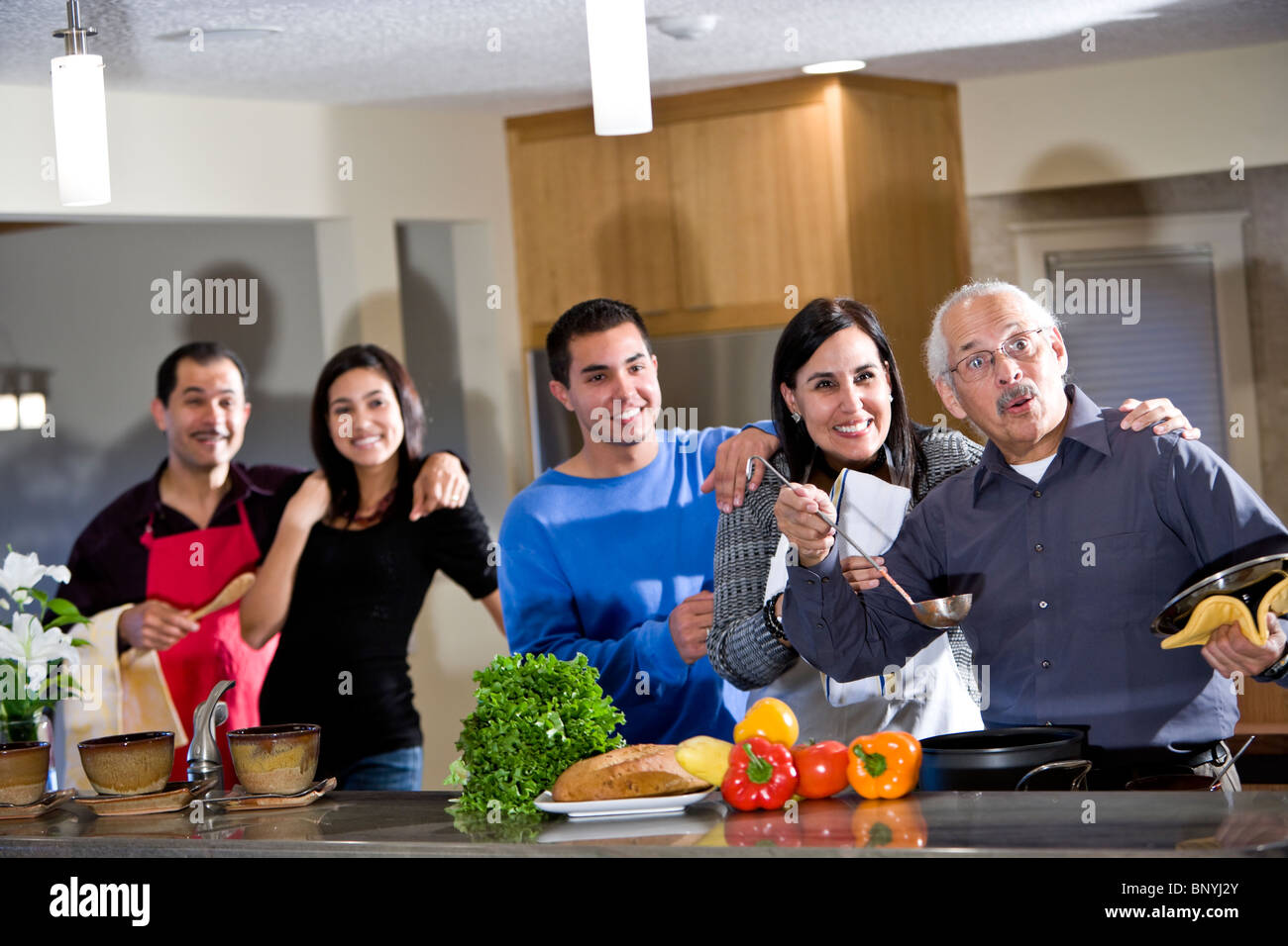 Three generation Hispanic family cooking in kitchen Stock Photo - Alamy