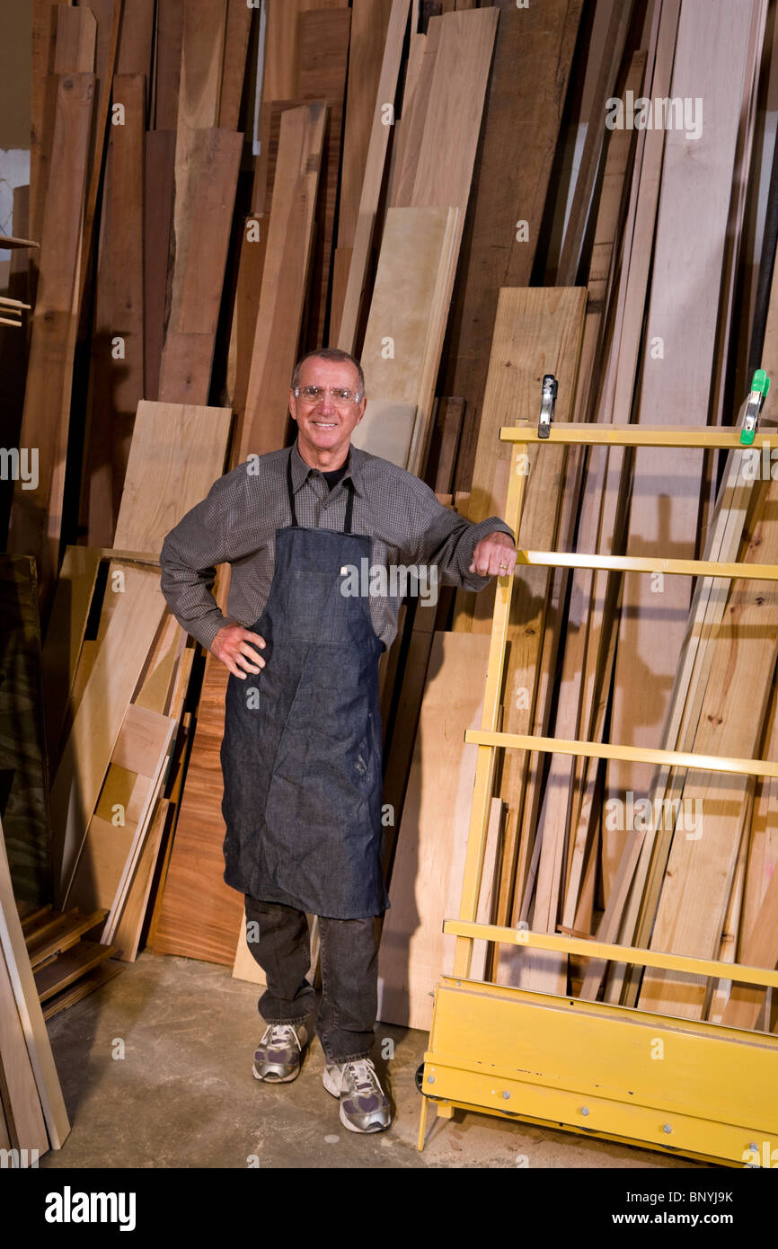Senior man in woodworking shop standing by lumber Stock Photo - Alamy