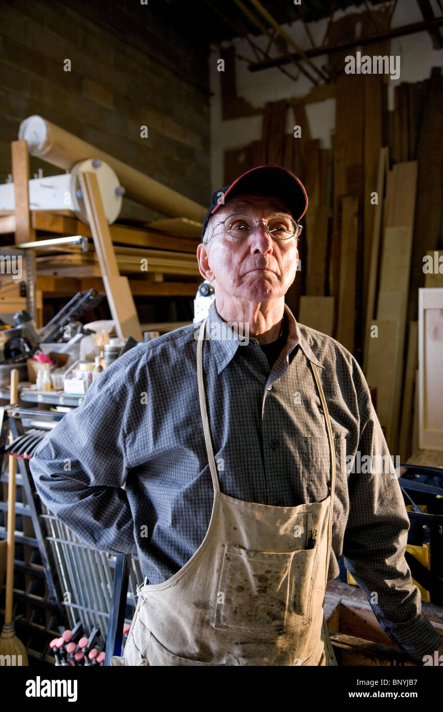 Senior man in woodworking shop by storage shelves Stock Photo - Alamy