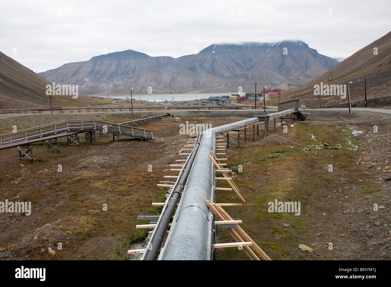 Utility pipes on raised covered platforms running above the ground at ...