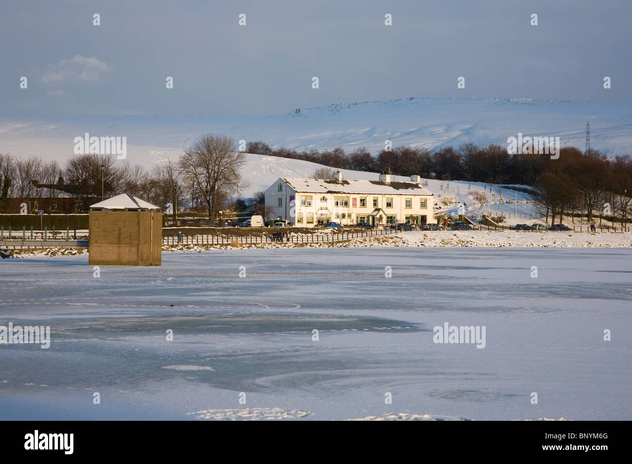 View towards The Fishermans Inn over frozen Hollingworth Lake at ...