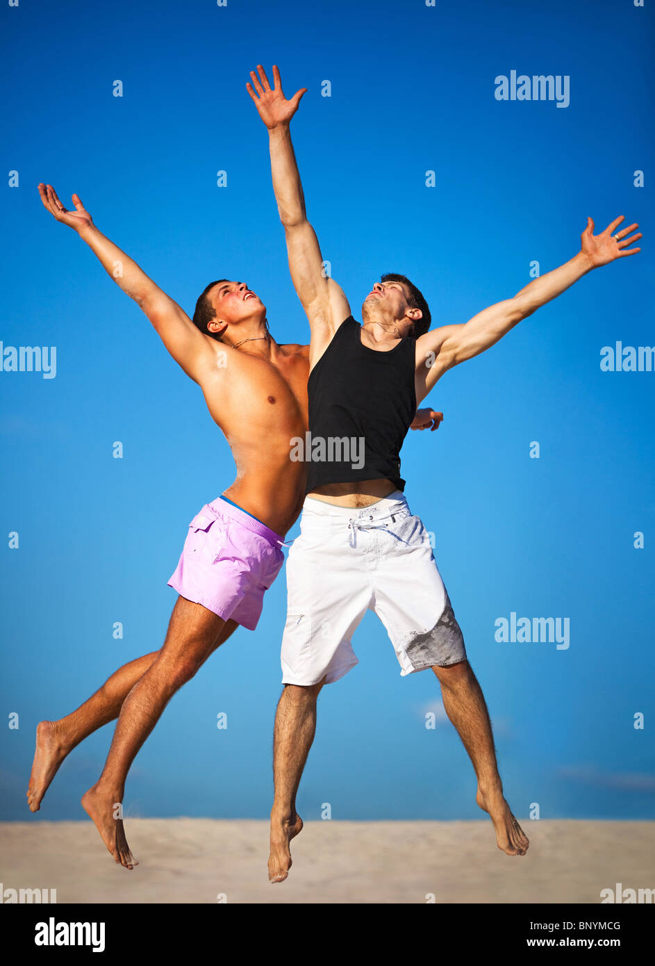 Two sportsmans jumping up high Stock Photo - Alamy