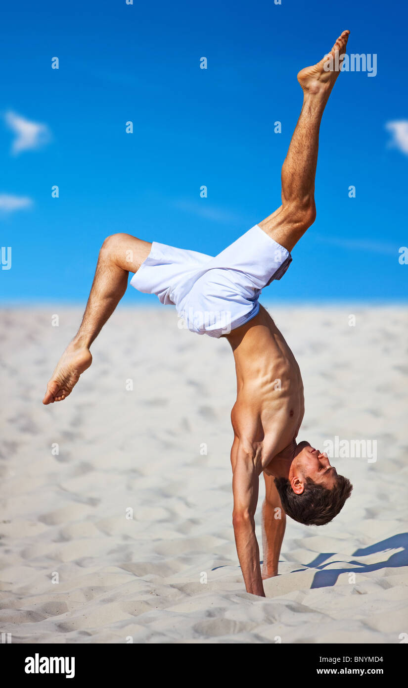 Young man dancing on beach Stock Photo - Alamy