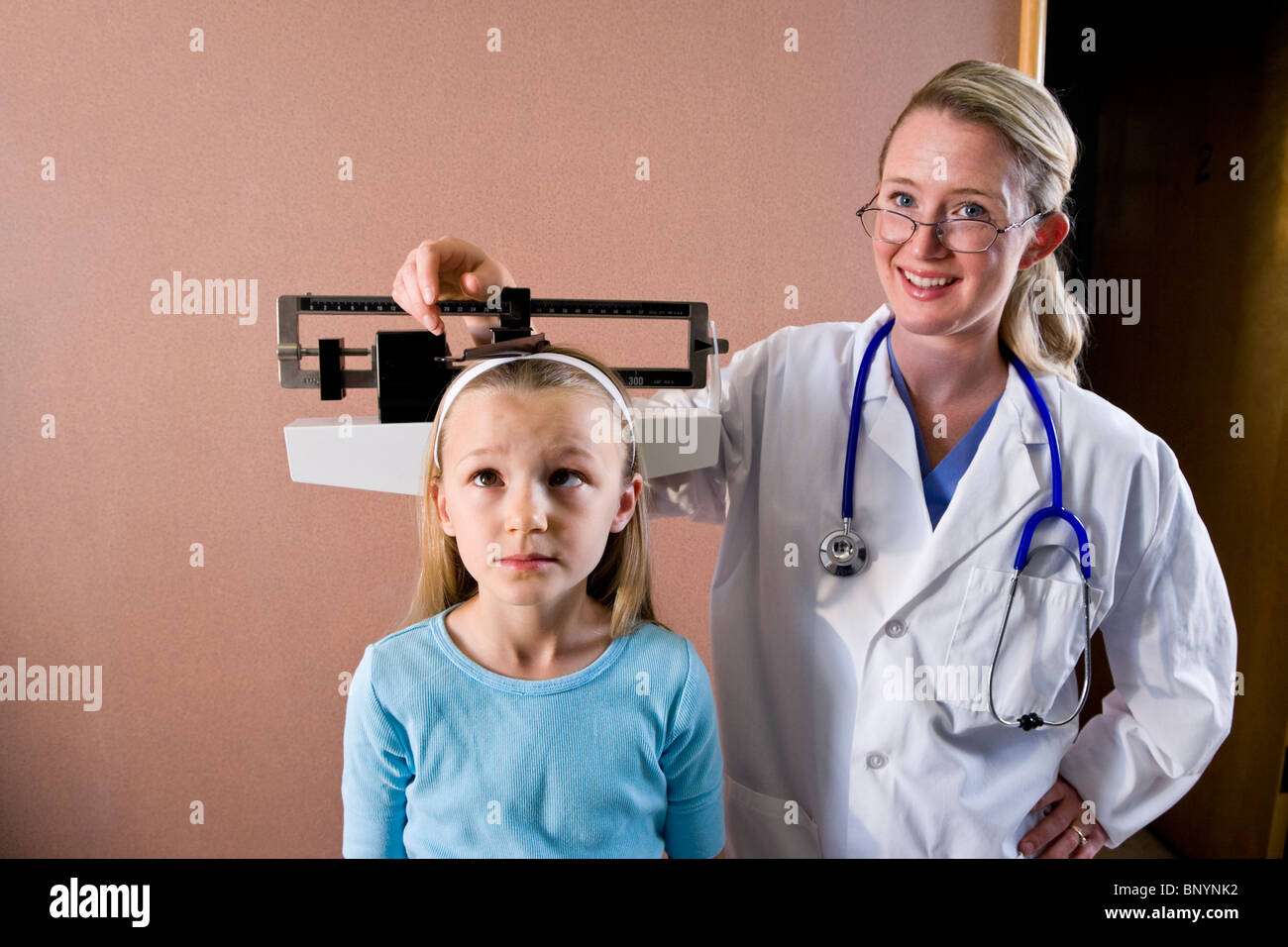 Annual checkup, doctor measuring child's height Stock Photo - Alamy