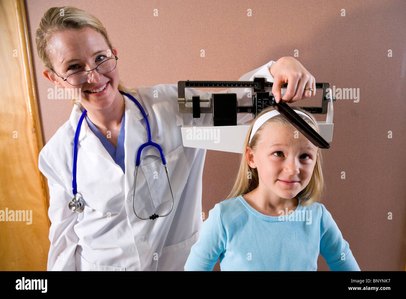 Annual checkup, doctor measuring child's height Stock Photo - Alamy