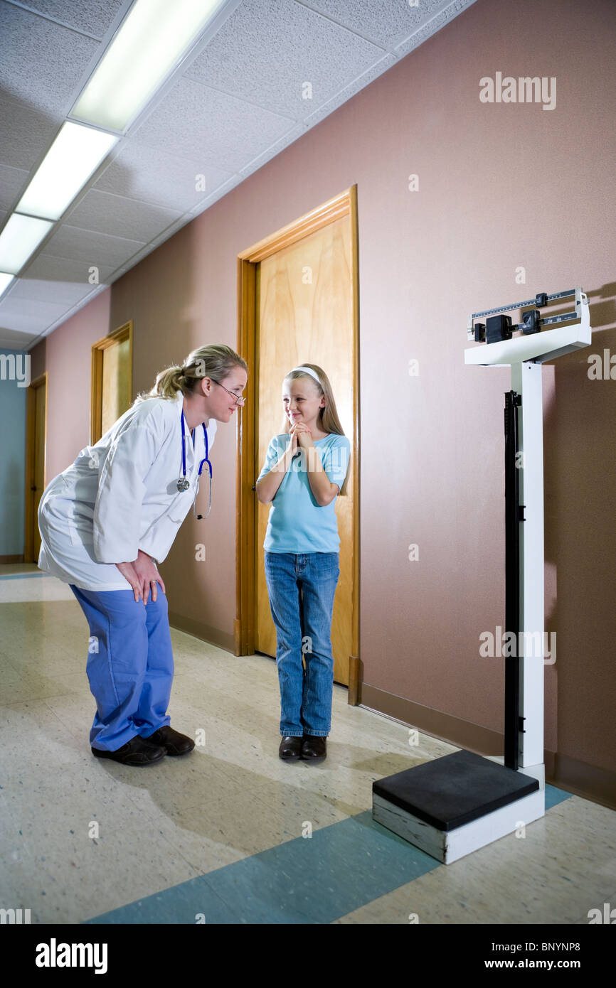 Friendly doctor talking with child getting annual check up Stock Photo ...