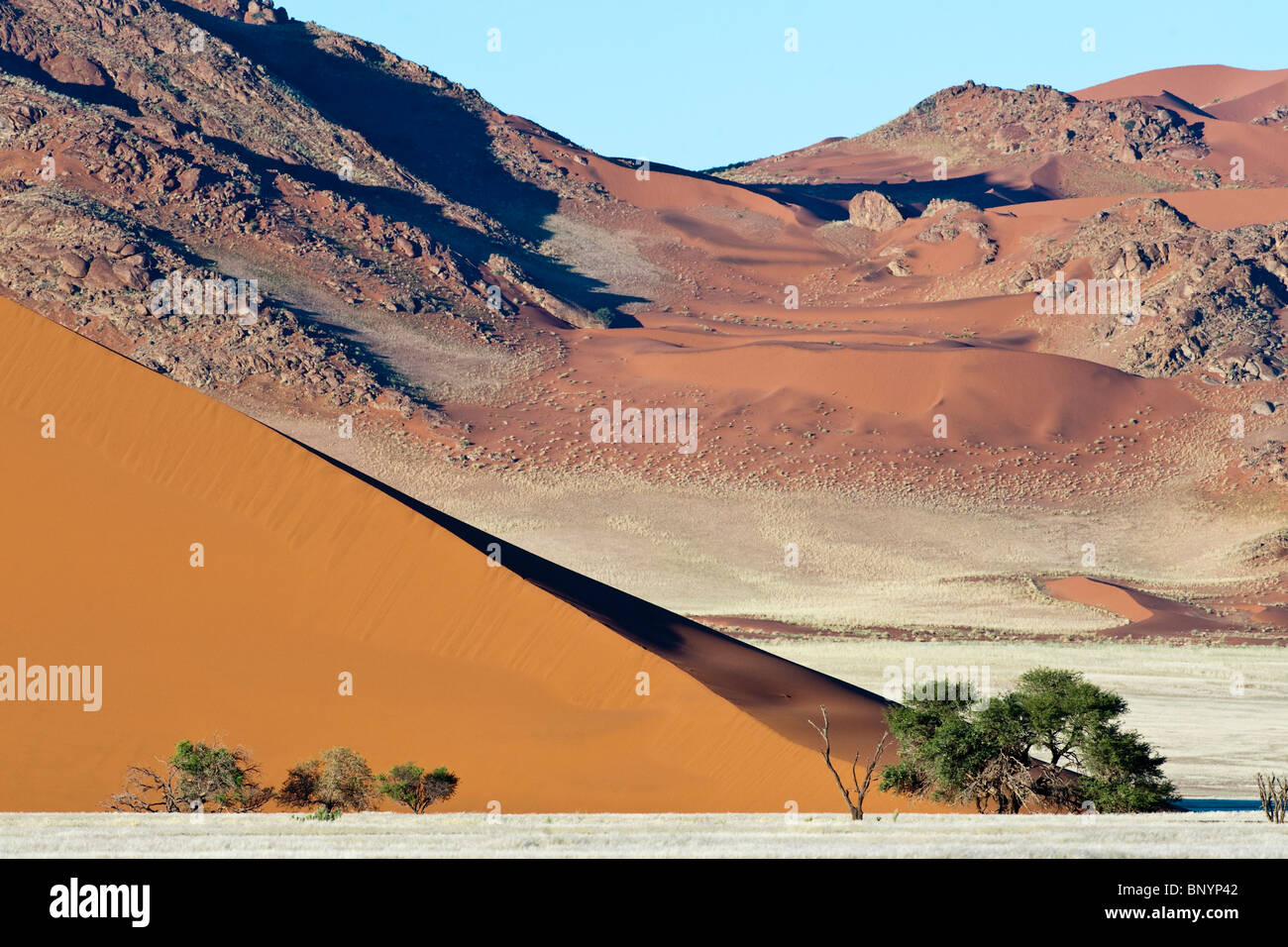 Red sand dunes and granite rocks at Sossusvlei in Naukluft Park Central ...