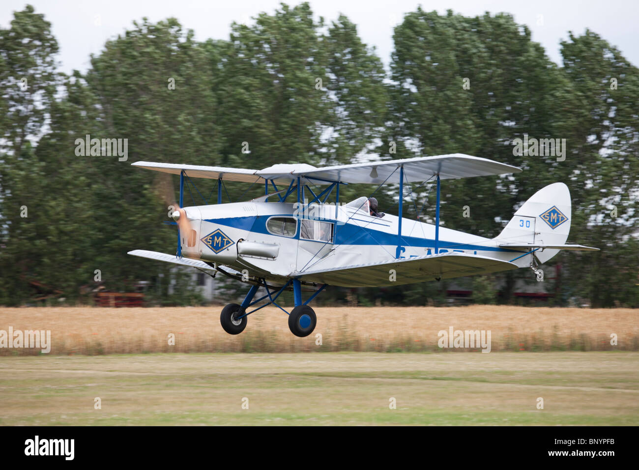 De Havilland DH-83 Fox Moth G-ACEJ in flight taking-off from Breighton ...