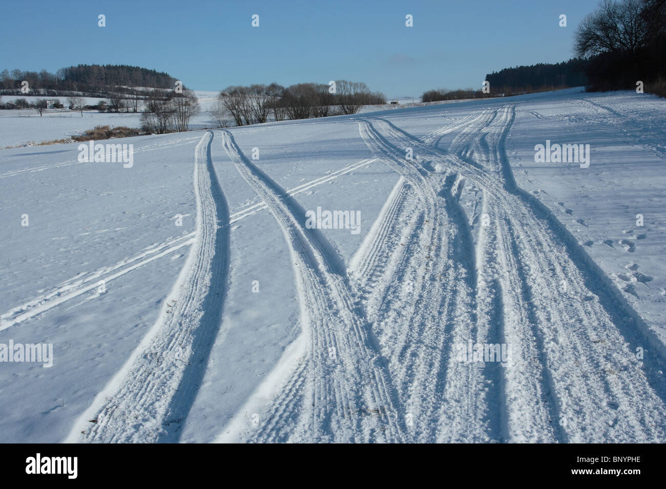 Wintry meadow and car rut Stock Photo - Alamy