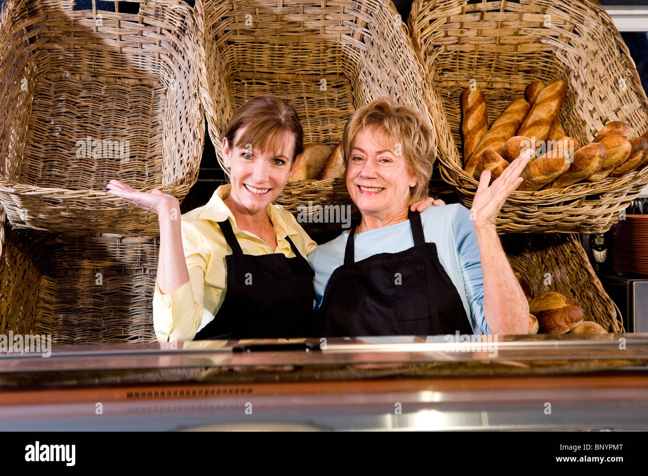 Workers behind counter in restaurant with bread baskets Stock Photo - Alamy