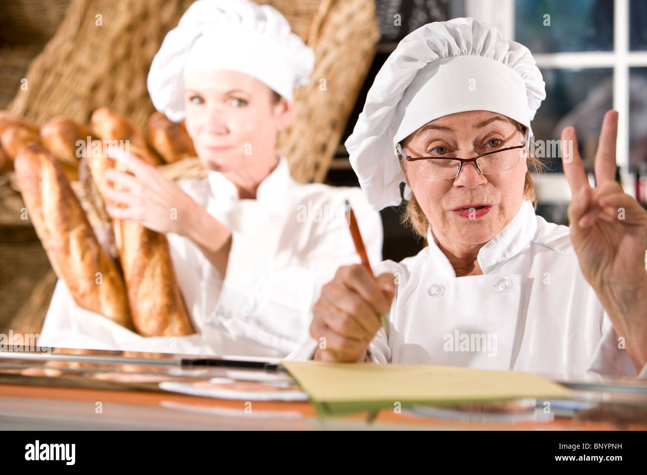 Baker working behind counter hi-res stock photography and images - Alamy