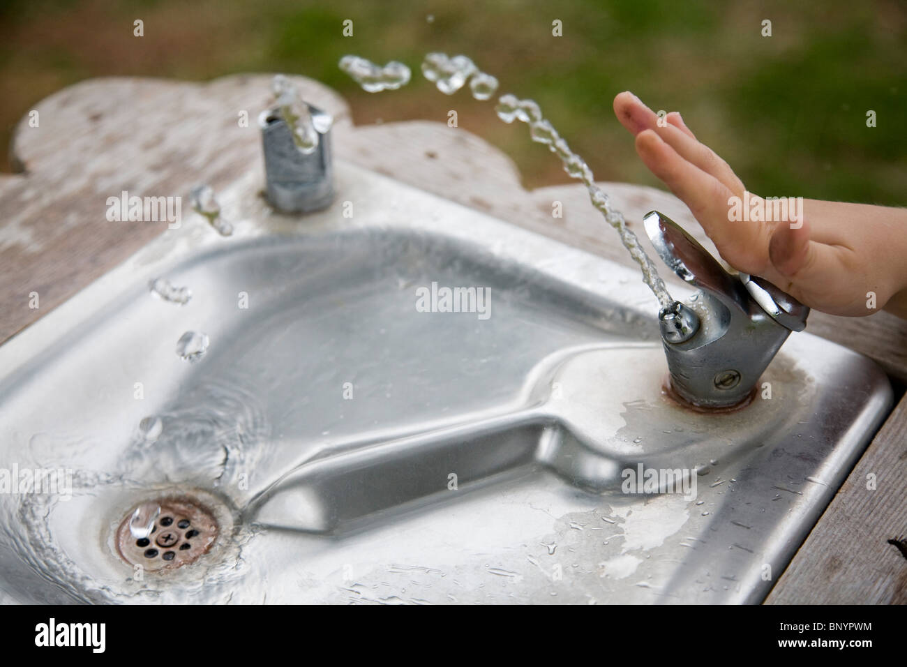 Child’s hand pushing a tap Stock Photo - Alamy