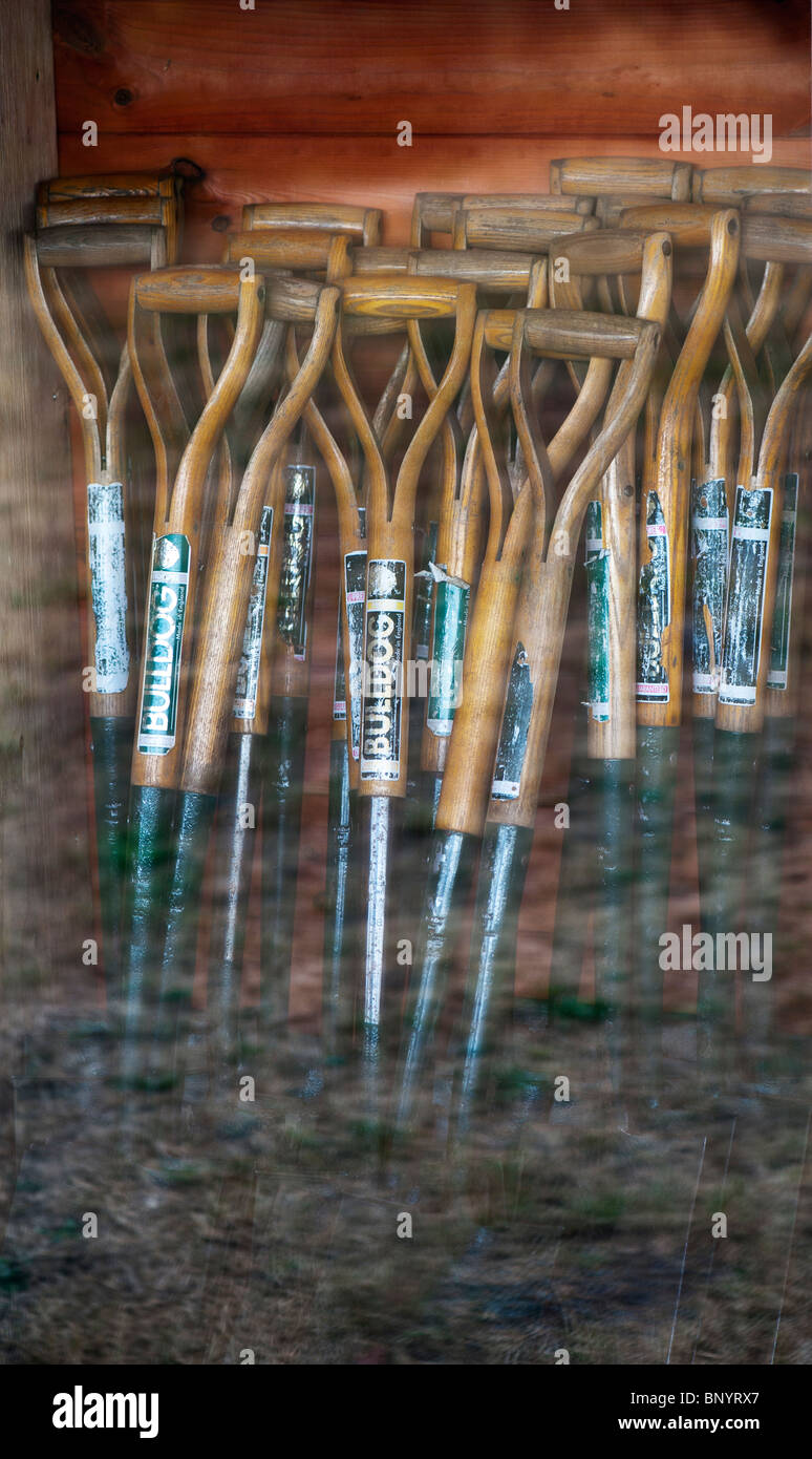Garden spades in a tool shed abstract Stock Photo - Alamy