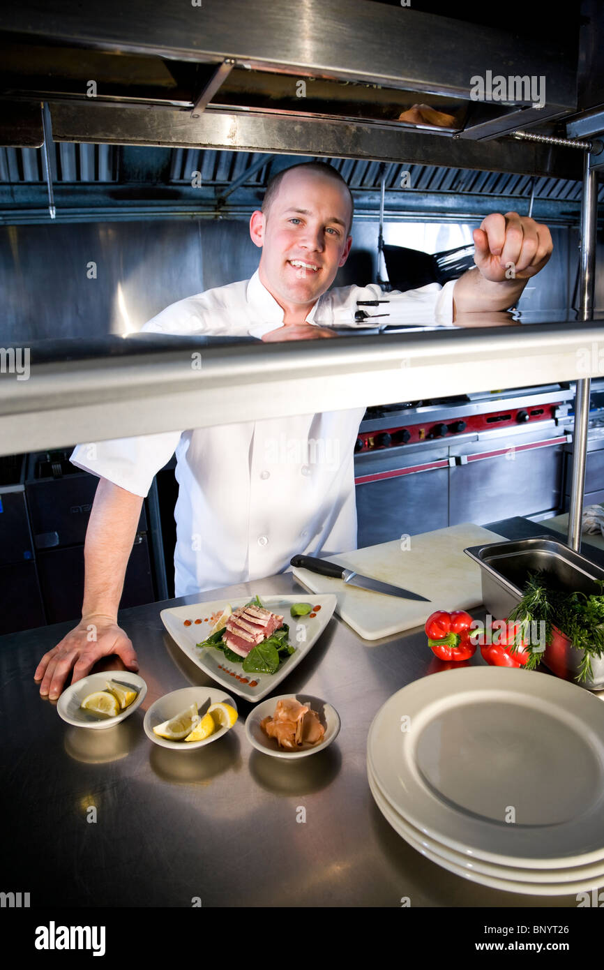 Chef in commercial kitchen preparing entree Stock Photo - Alamy