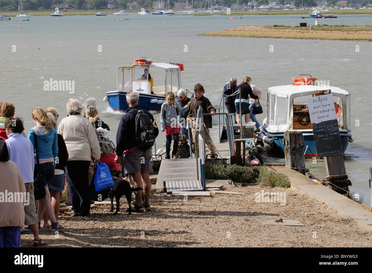 Tourists boarding the small passenger ferry which operates between ...