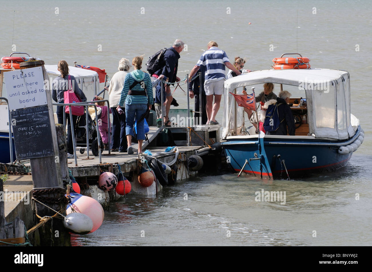 Tourists boarding the small passenger ferry which operates between ...