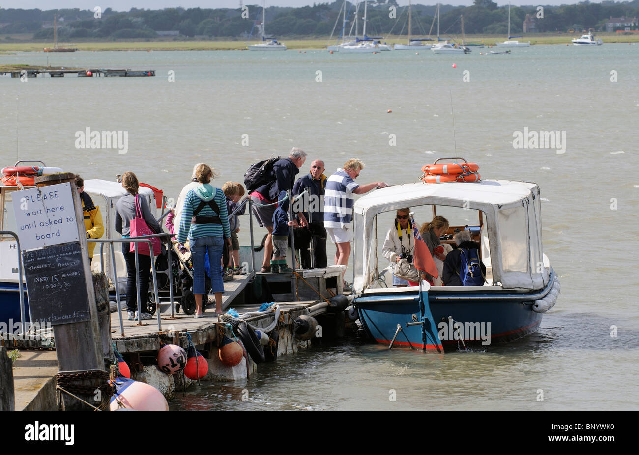Tourists boarding the small passenger ferry which operates between ...