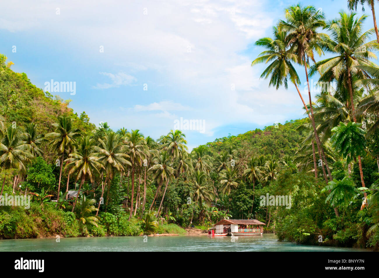 A floating house on the shore of a tropical jungle river Stock Photo ...