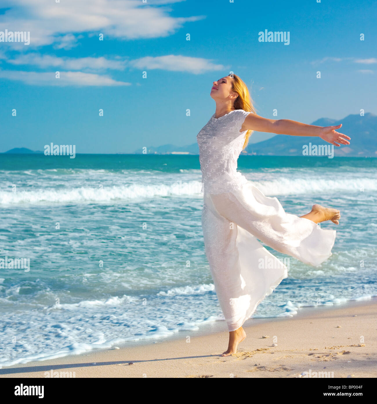 Young woman dancing near the ocean Stock Photo - Alamy