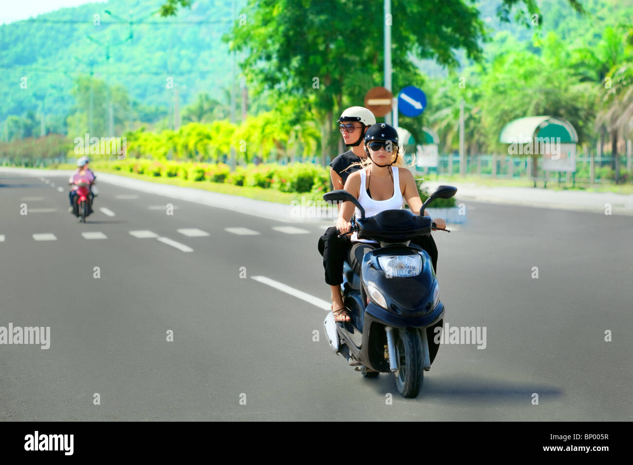 Asian women driving motorbike hi-res stock photography and images - Alamy