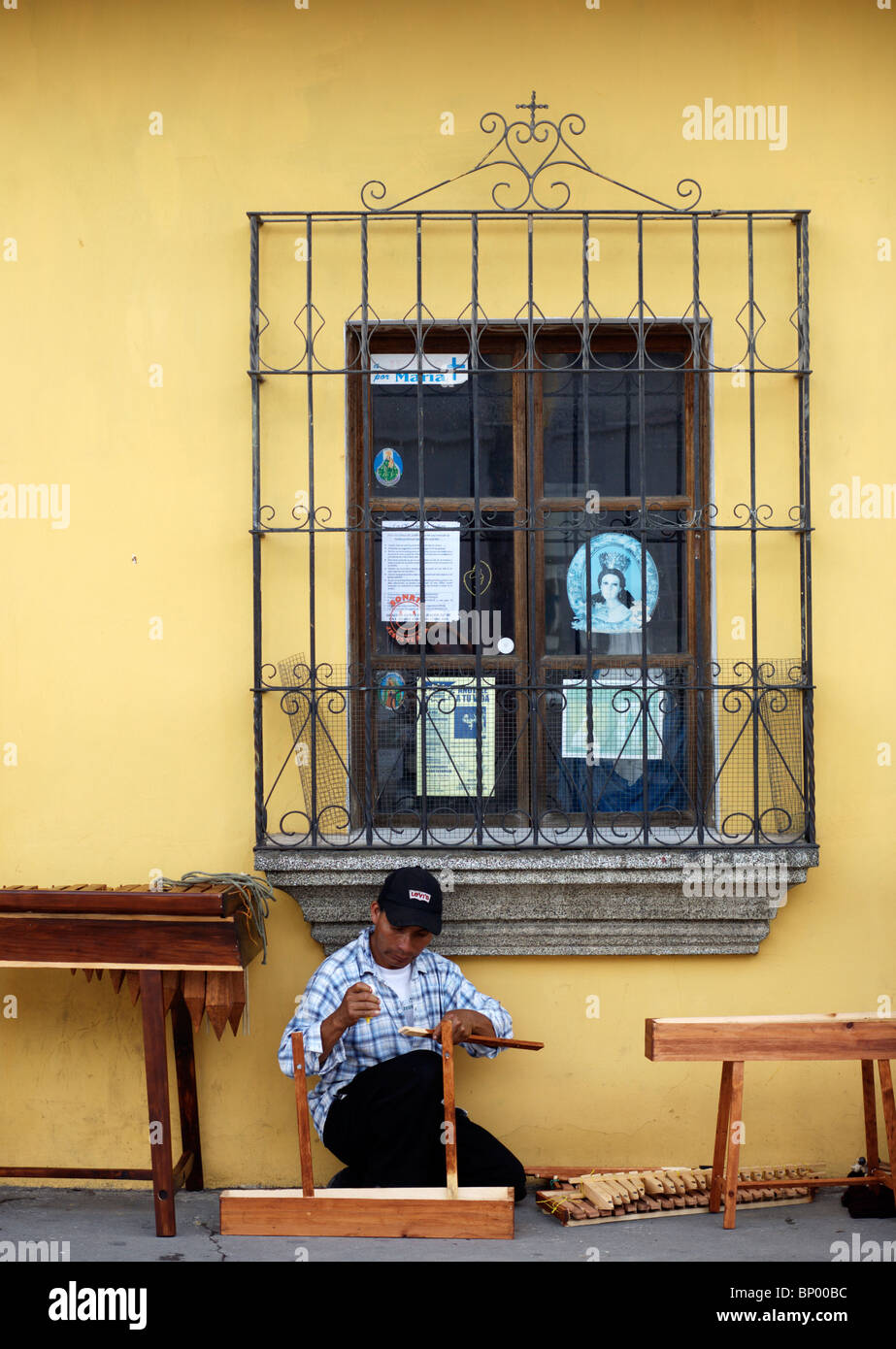 A man makes a traditional marimba musical instrument in the street in ...
