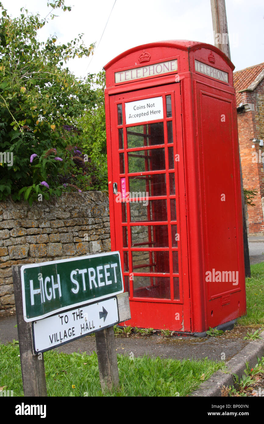 A traditional red telephone box on a street in a U.K. village Stock ...
