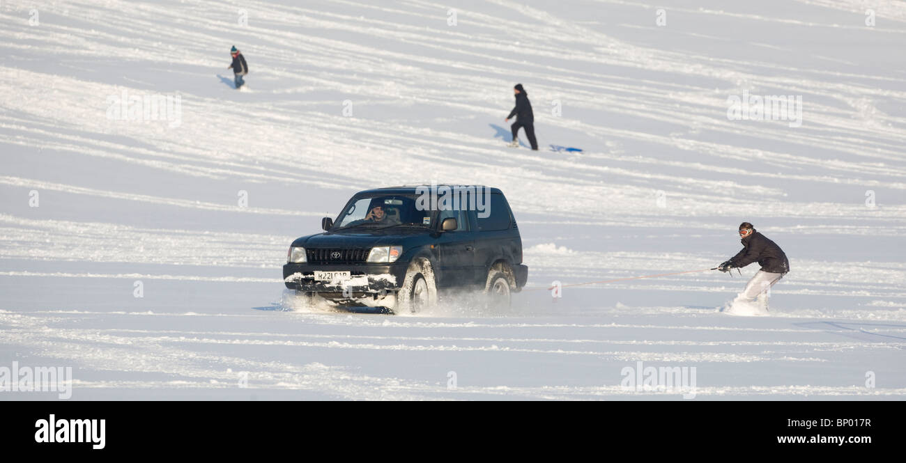 Snowborder towed 4x4 through thick hi-res stock photography and images ...