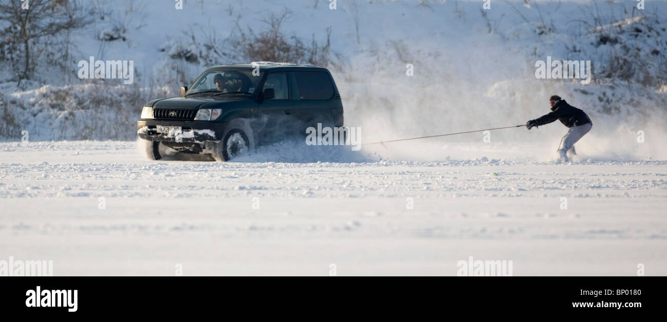 Snowborder towed 4x4 through thick hi-res stock photography and images ...