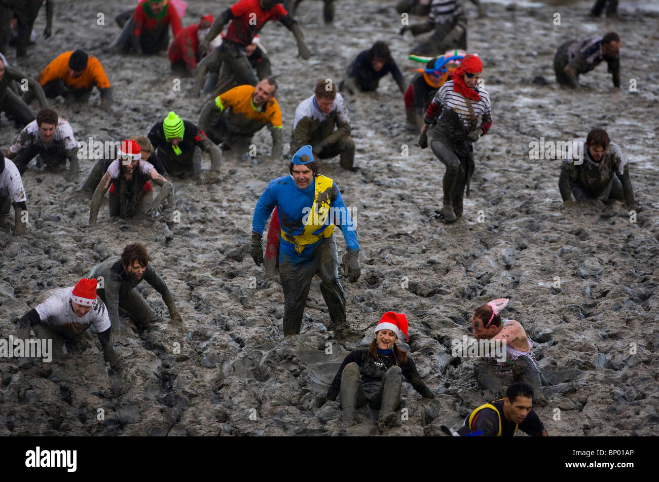 Mud covered Competitors near the finish line during the Maldon Mud Race ...