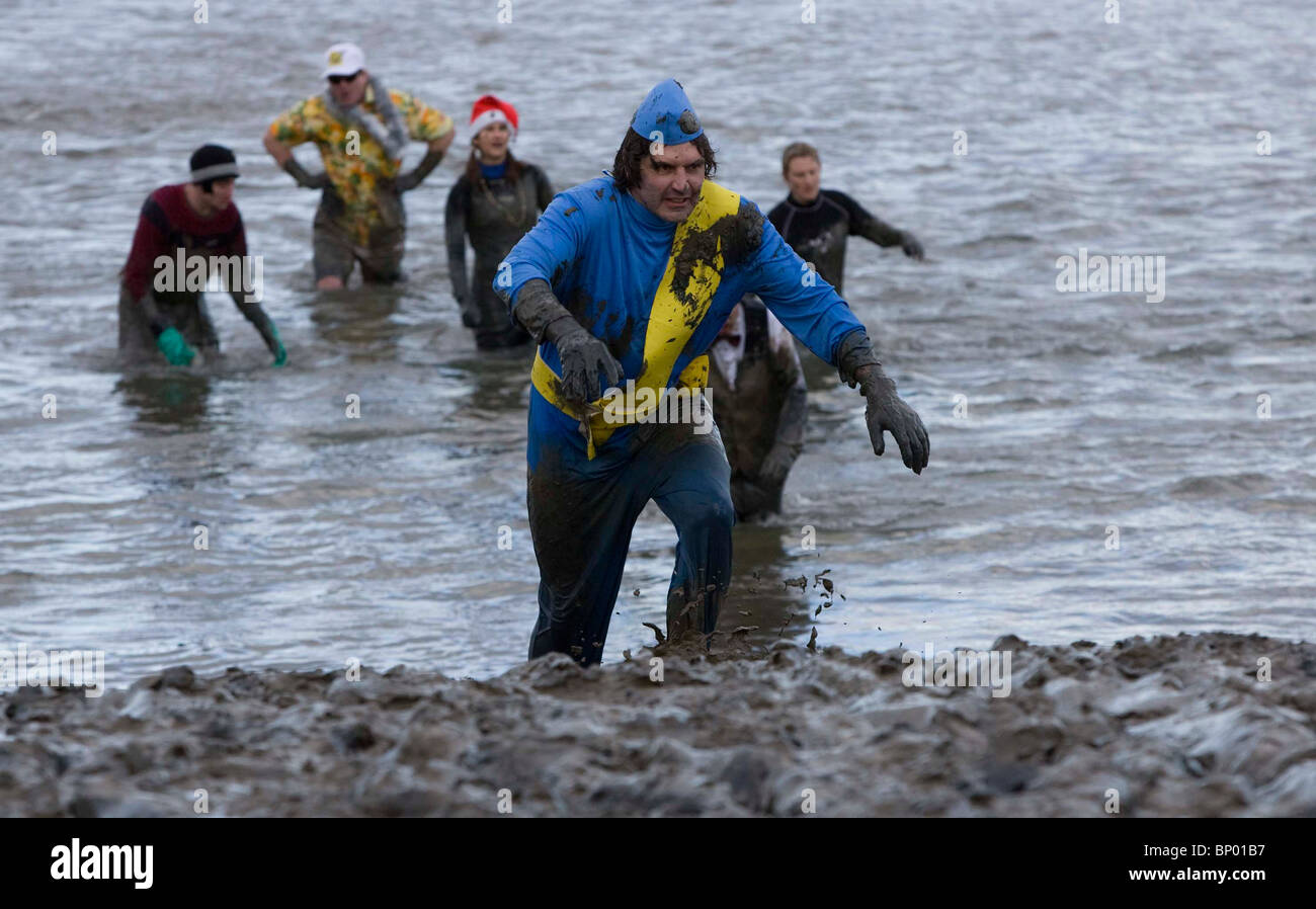 A mud covered Competitor dressed as a Thunderbird reaches the finish ...
