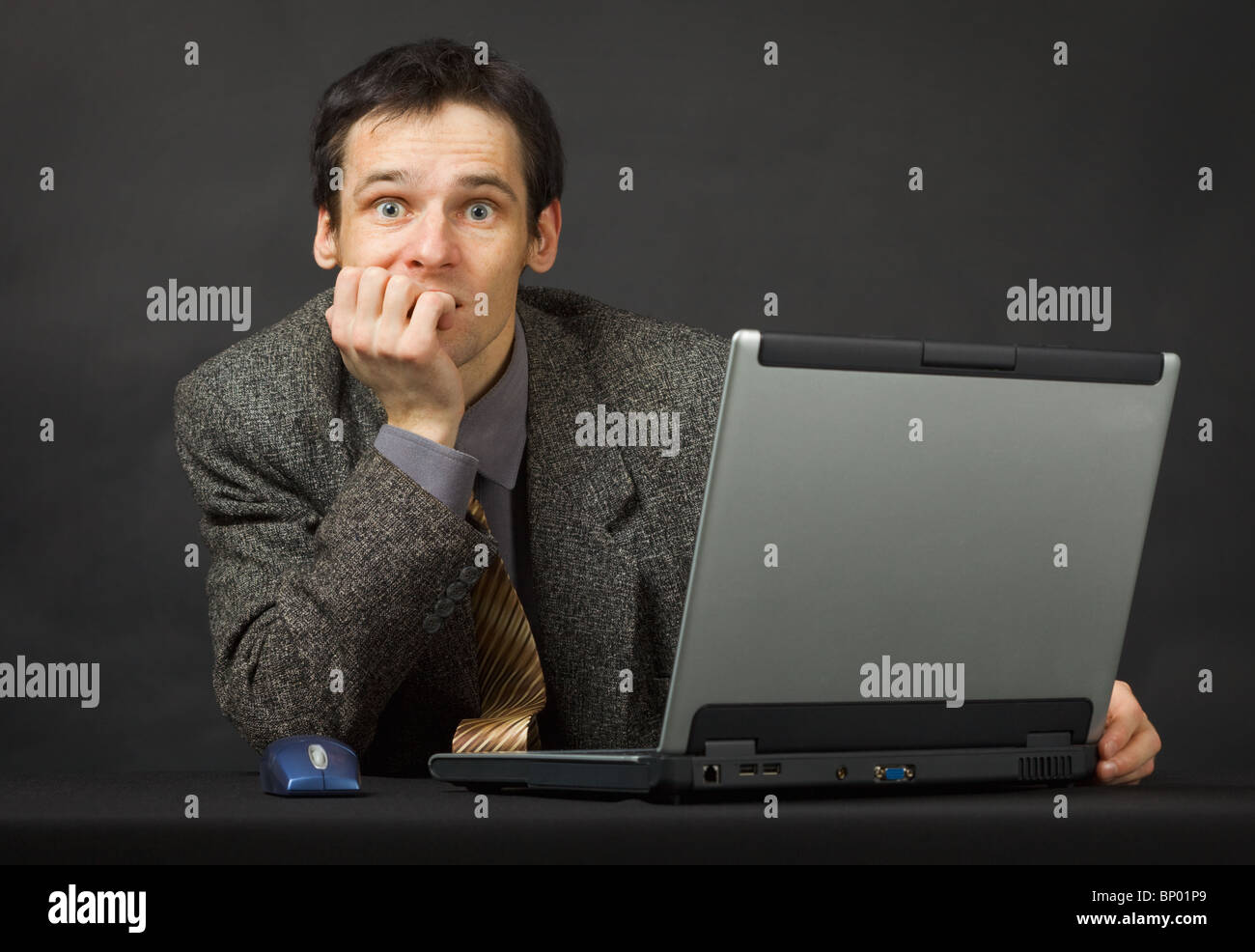 The surprised person with the computer. Sits and thinks Stock Photo - Alamy