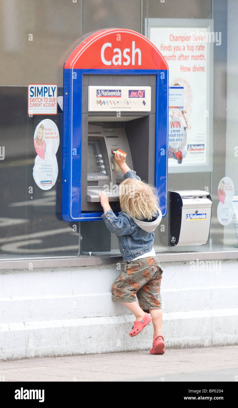 A young boy plays at a cash point machine. Picture by James Boardman ...