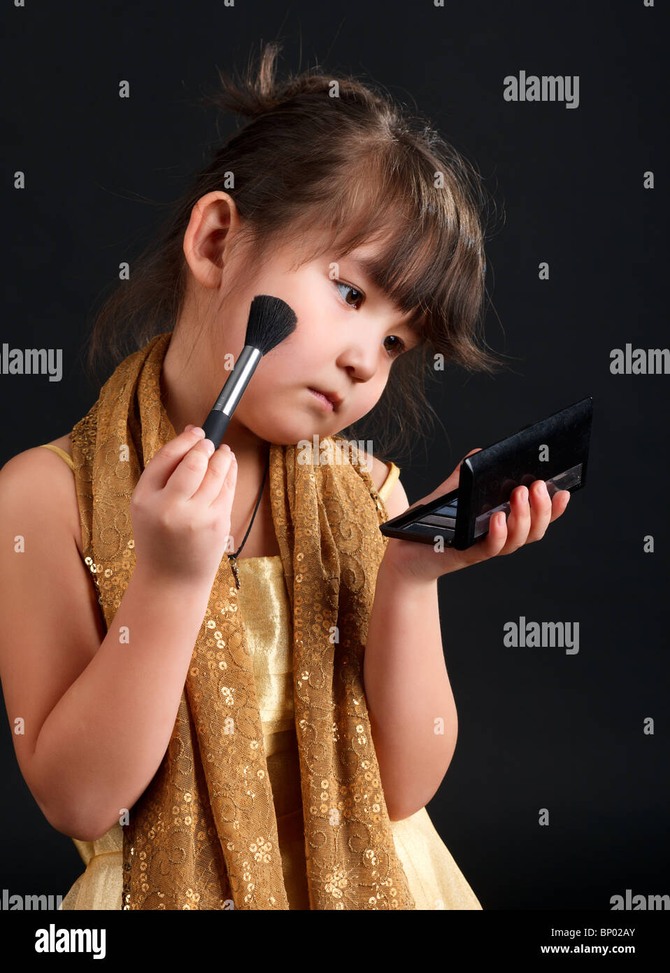 Little fashion model with cosmetic brush Stock Photo - Alamy