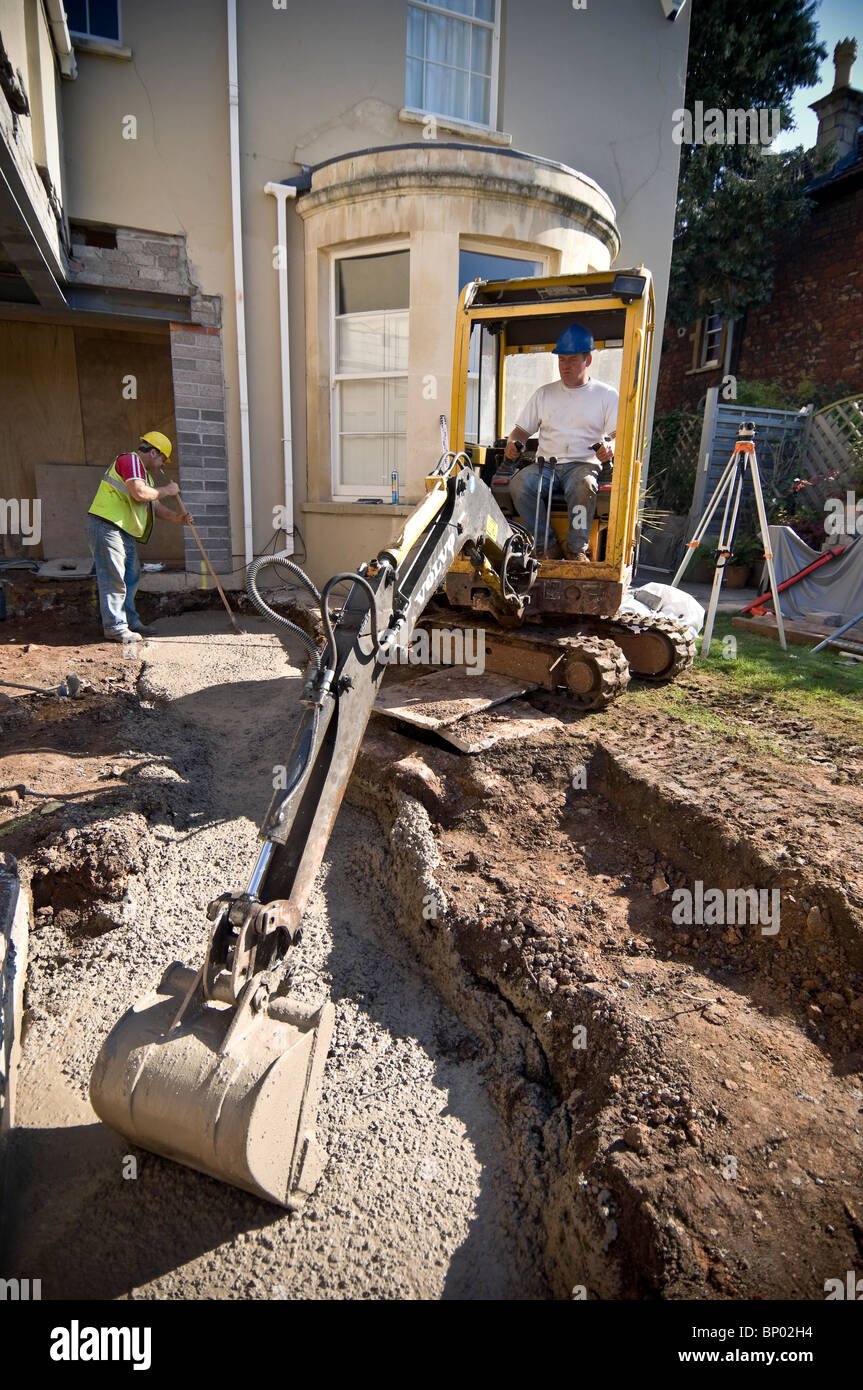 Digger preparing foundations with wet cement Stock Photo - Alamy