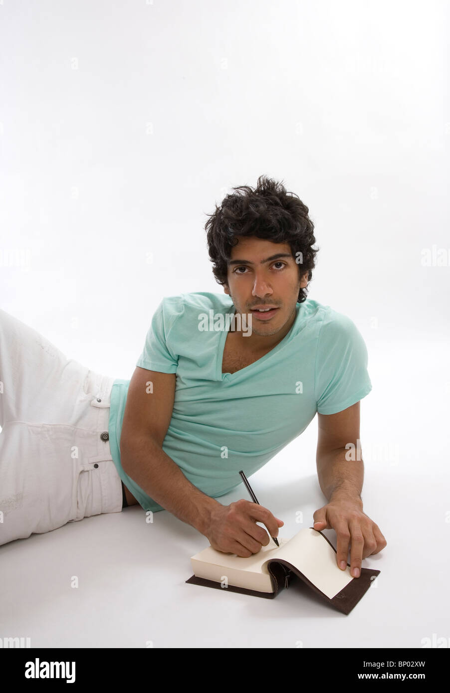 Male writing in notebook Stock Photo - Alamy