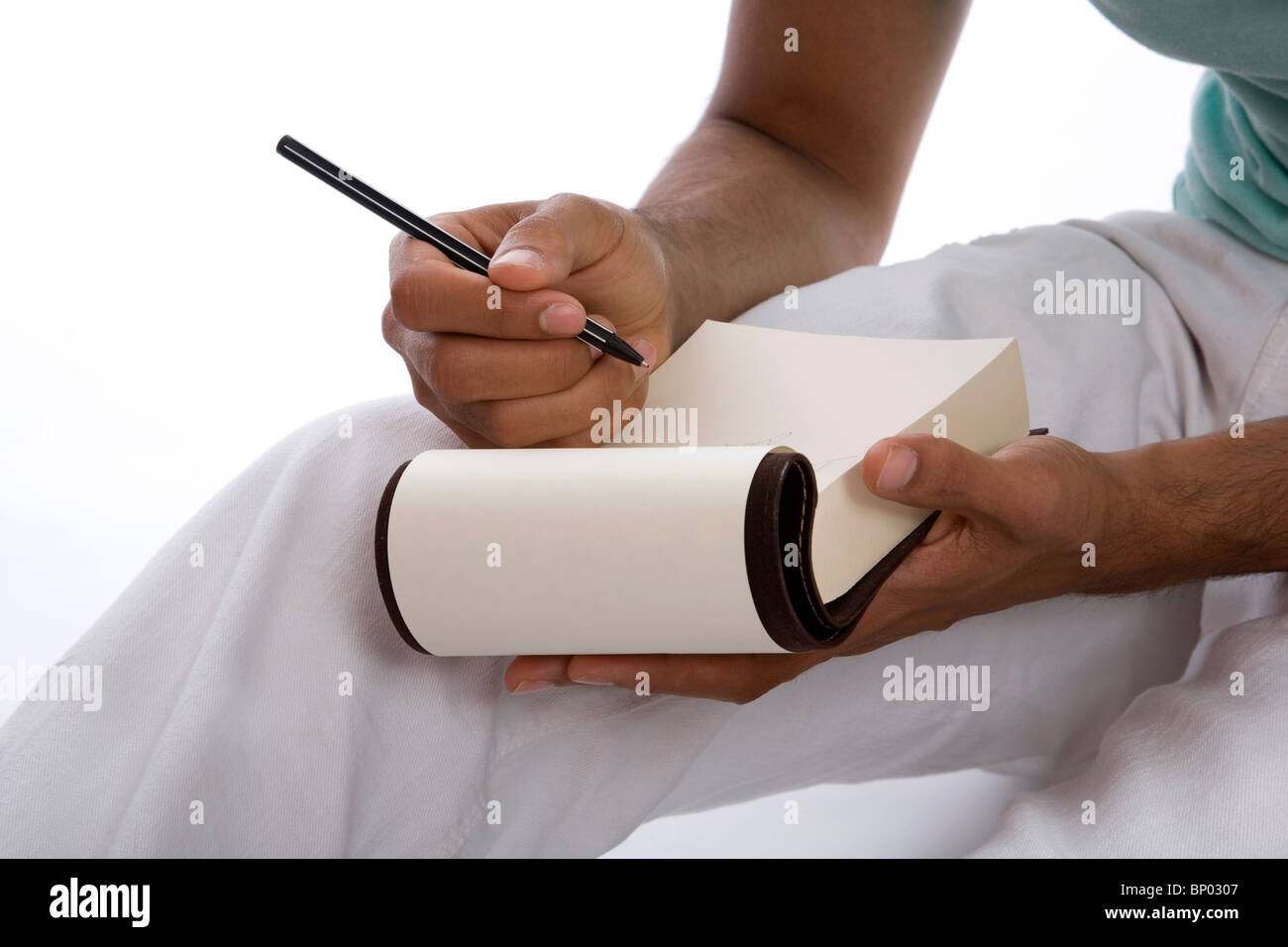 Male writing in notebook Stock Photo - Alamy