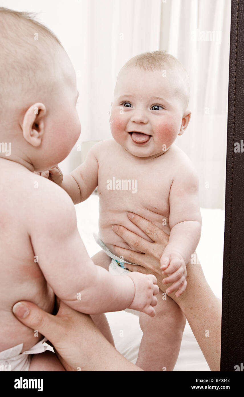 Beautiful Shot of a Cute Baby Looking in the Mirror Stock Photo - Alamy