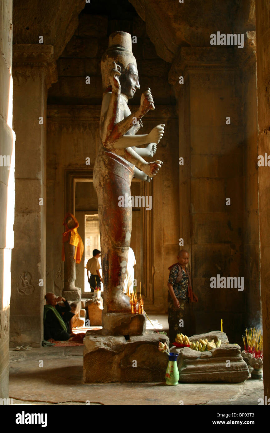 still people bring offerings to this multi armed statue inside Angkor ...