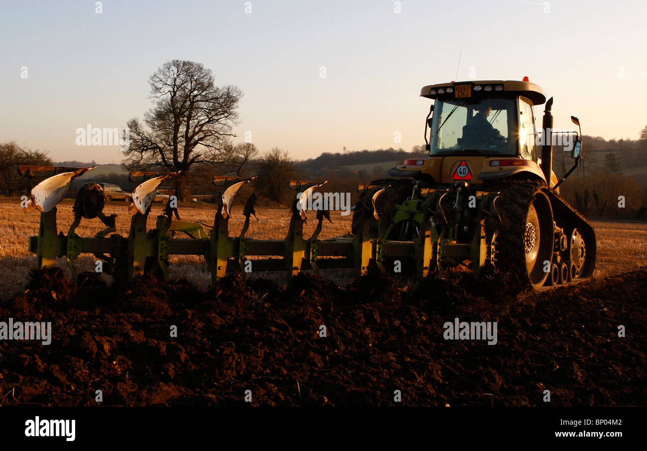 Caterpillar Challenger tractor pulling a reversible plough Stock Photo ...