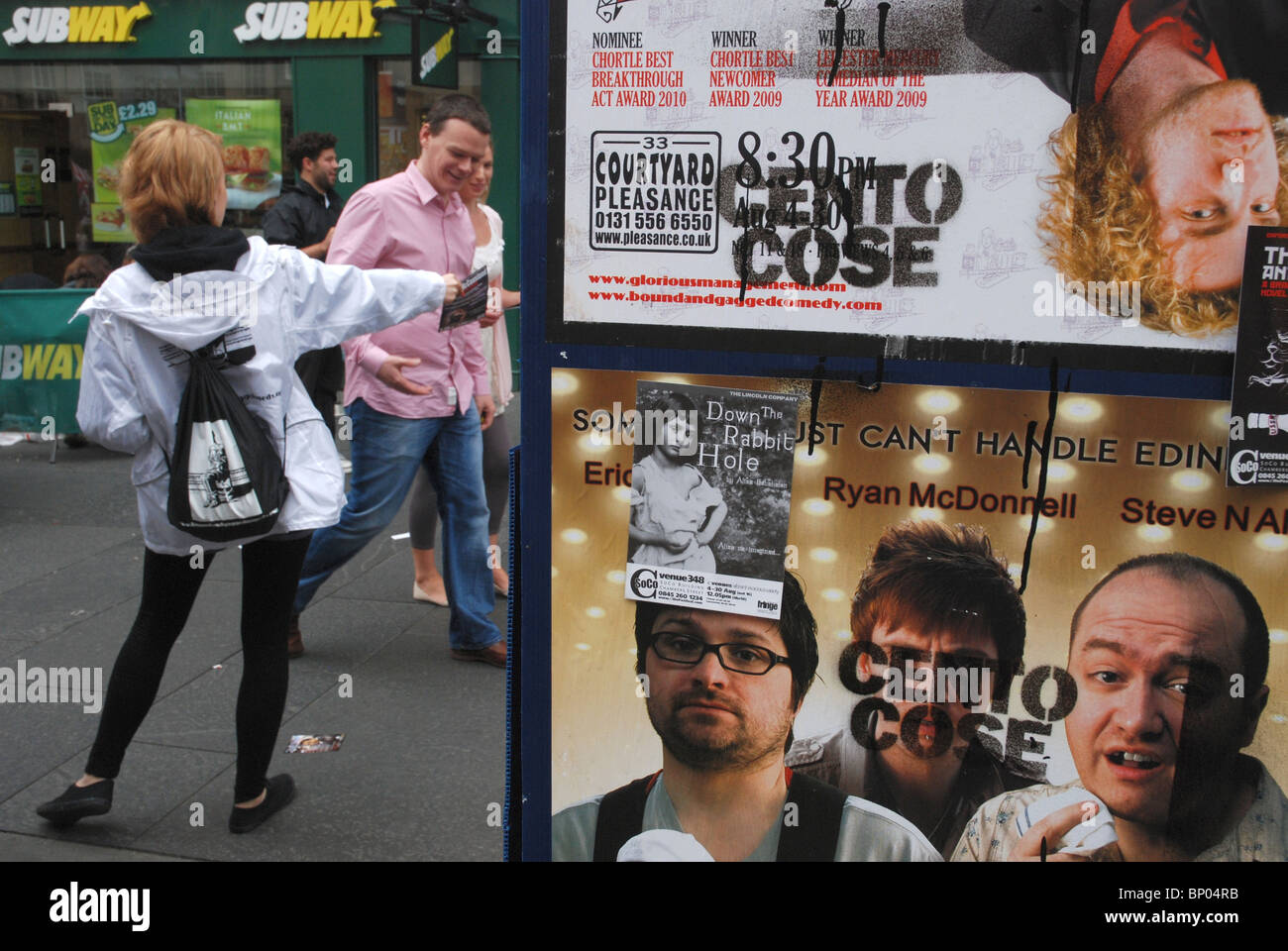 Girl handing out fliers on the Royal Mile in Edinburgh with posters for ...