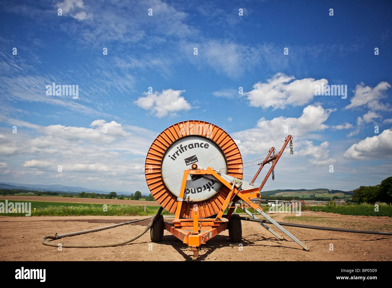 Water irrigator in afield against blue sky Stock Photo - Alamy