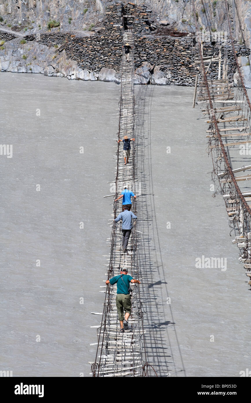 Pakistan - Karakorum - Hunza Valley - tourists crossing a suspension ...