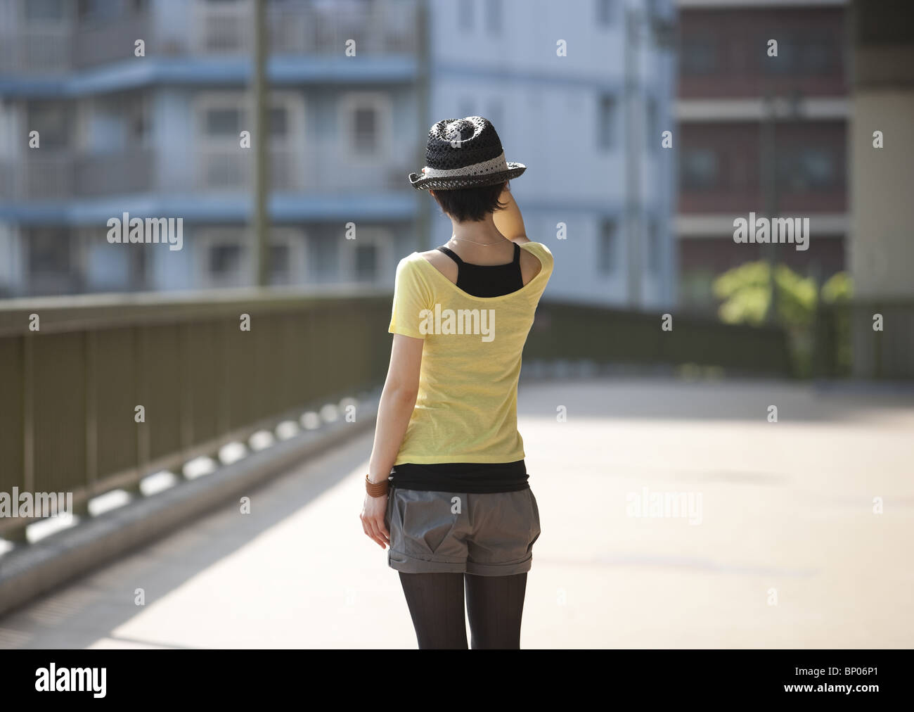 Young woman standing on bridge Stock Photo - Alamy