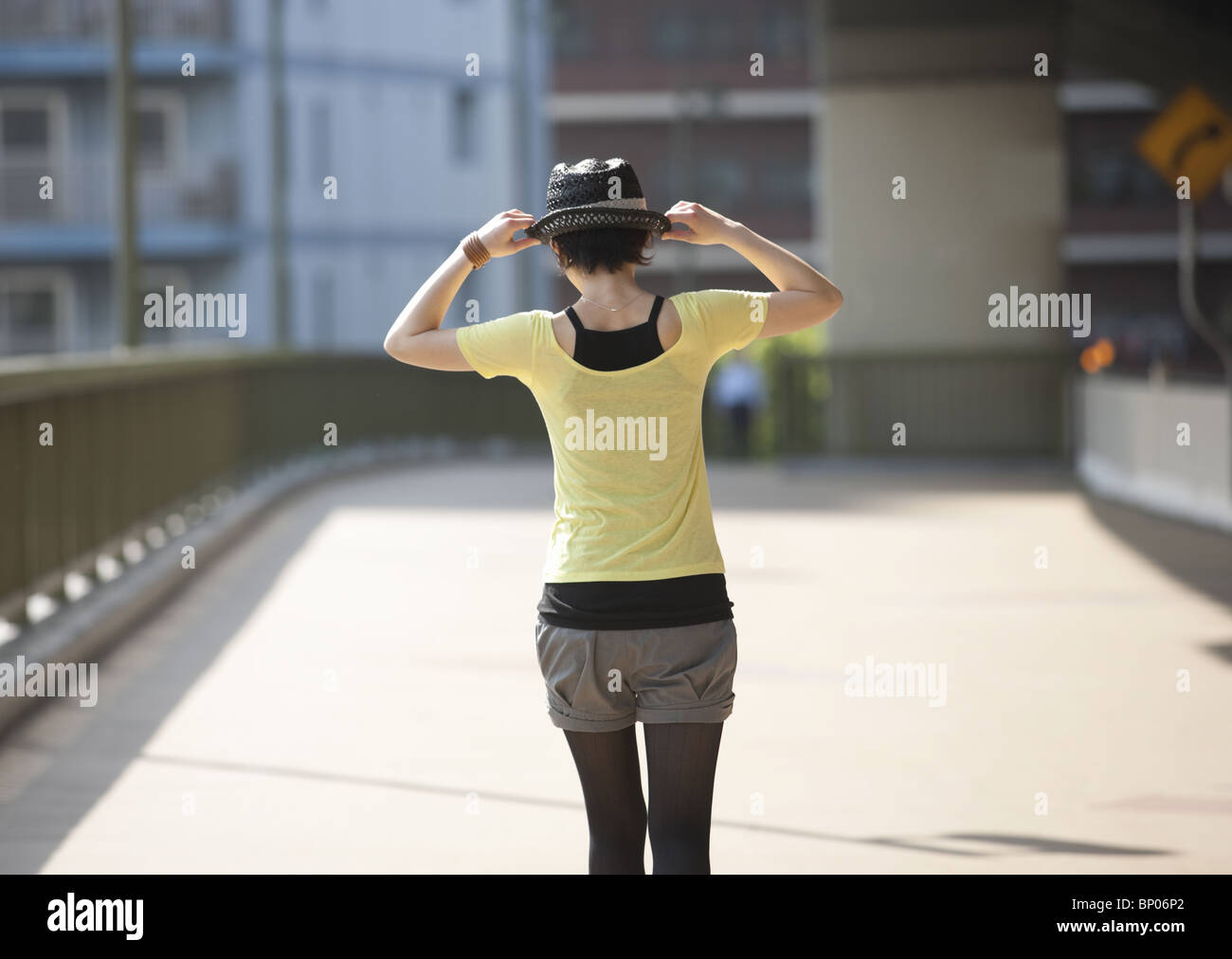 Young woman standing on bridge Stock Photo - Alamy