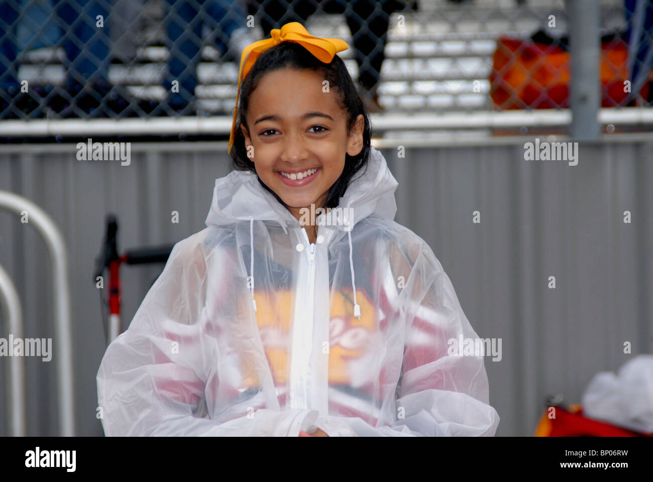 A little smiling high school cheerleader in the rain in Riverdale ...