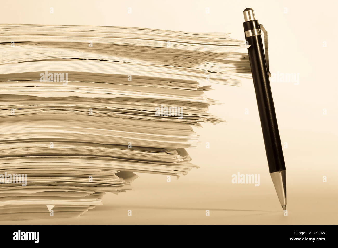 a pen near stack of paper Stock Photo - Alamy