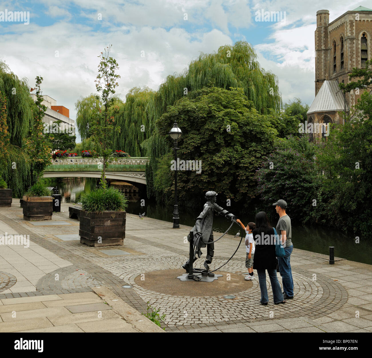 Family interacting with modern street sculpture, called The bargeman ...