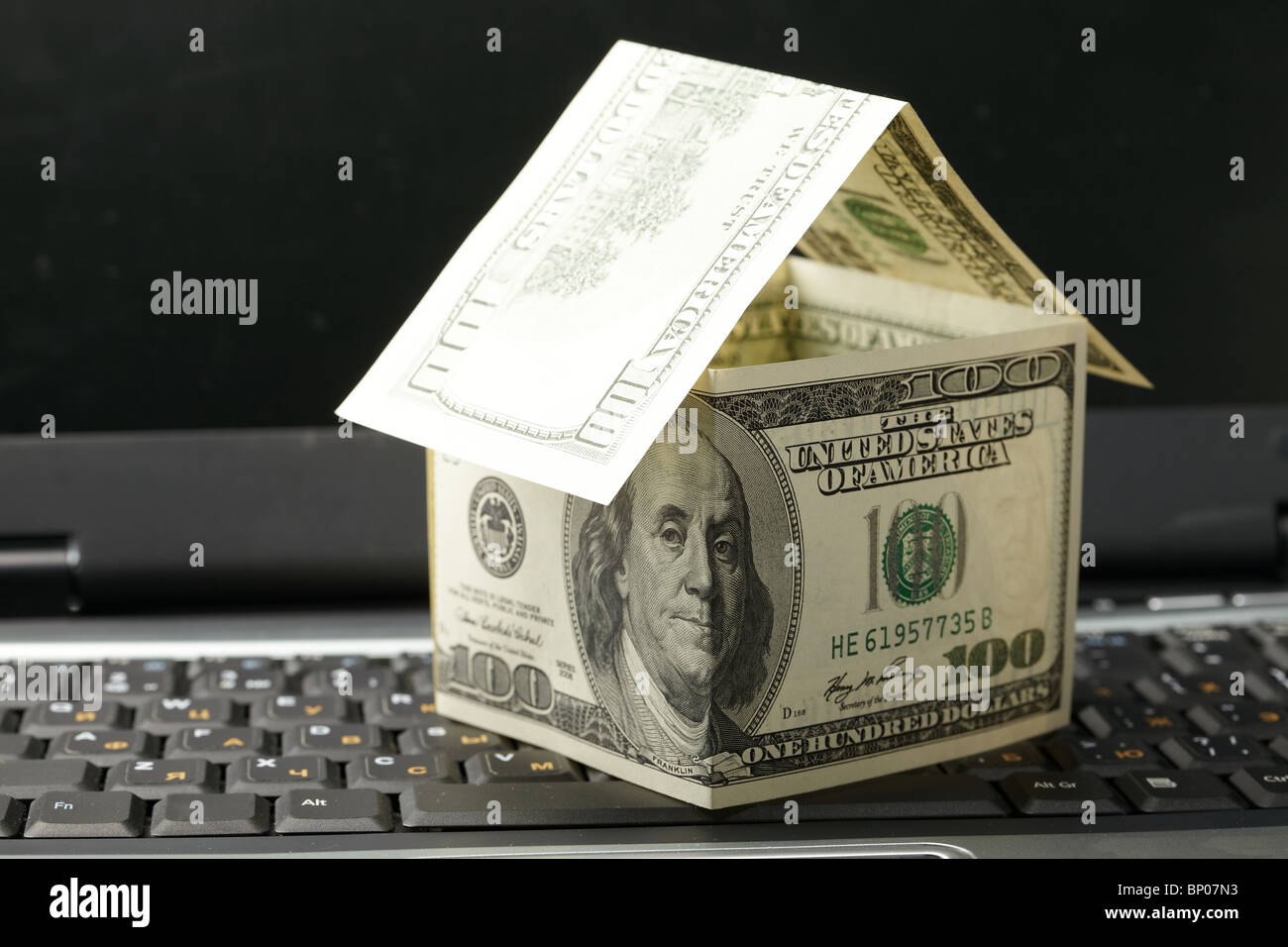 dollars on the keyboard Stock Photo - Alamy