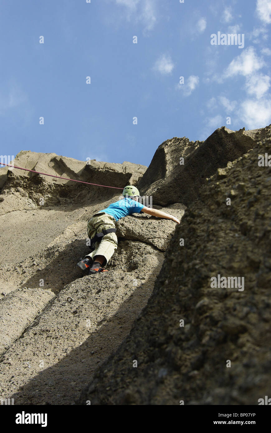 boy climbing by escalation a mountain as sport Stock Photo - Alamy